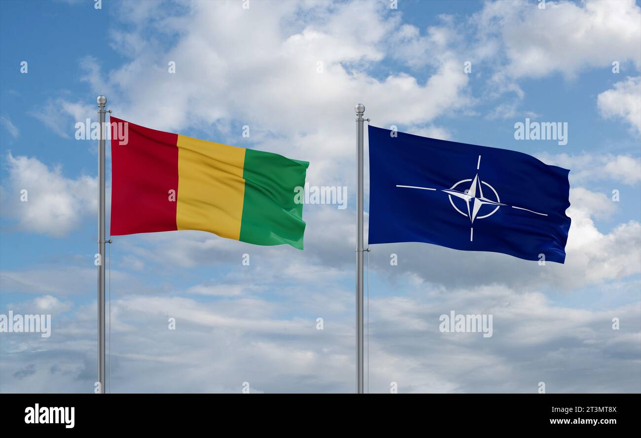 NATO and Guinea-Conakry, Guinea flags waving together on blue cloudy ...