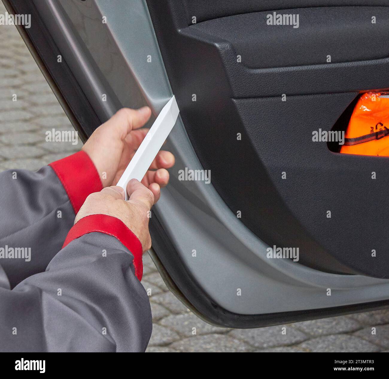 working with dismantling tool for bodywork on a car Stock Photo - Alamy