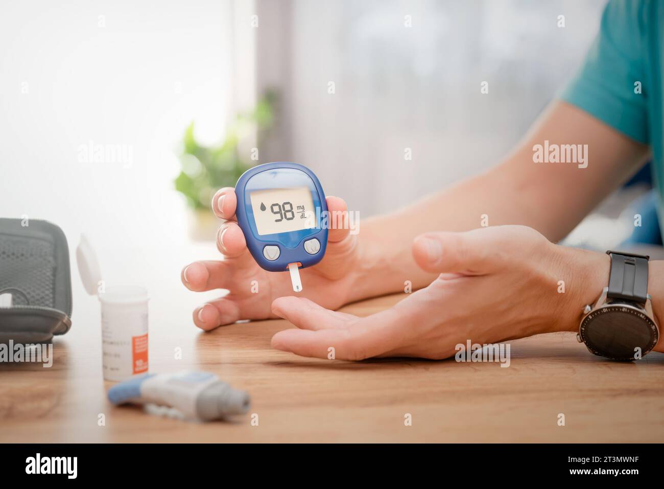 Diabetes doing sugar blood test, using glucometer Stock Photo - Alamy