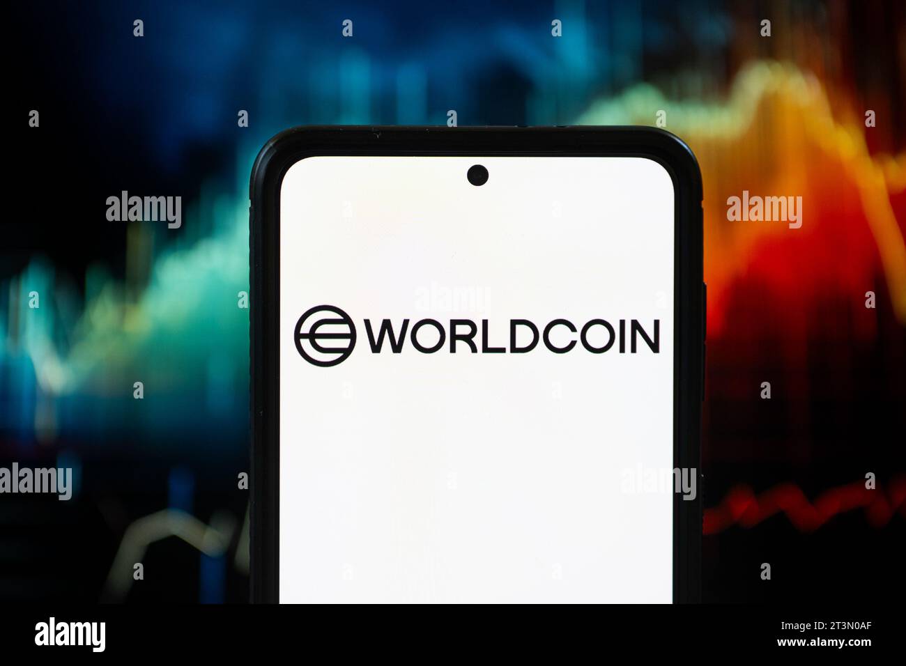 In this photo illustration a Worldcoin logo seen displayed on a ...