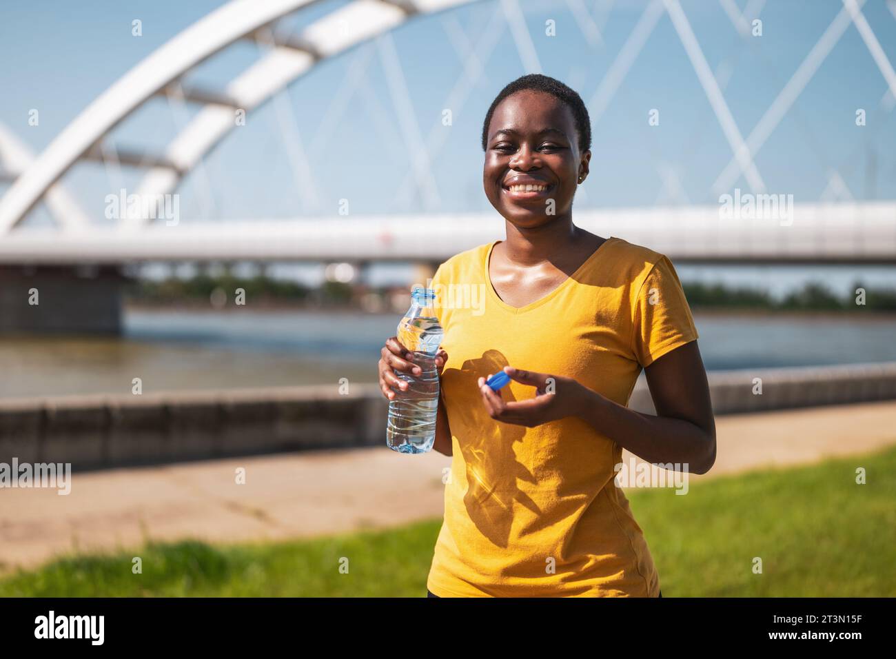 Woman drinking water while exercise outdoor Stock Photo - Alamy