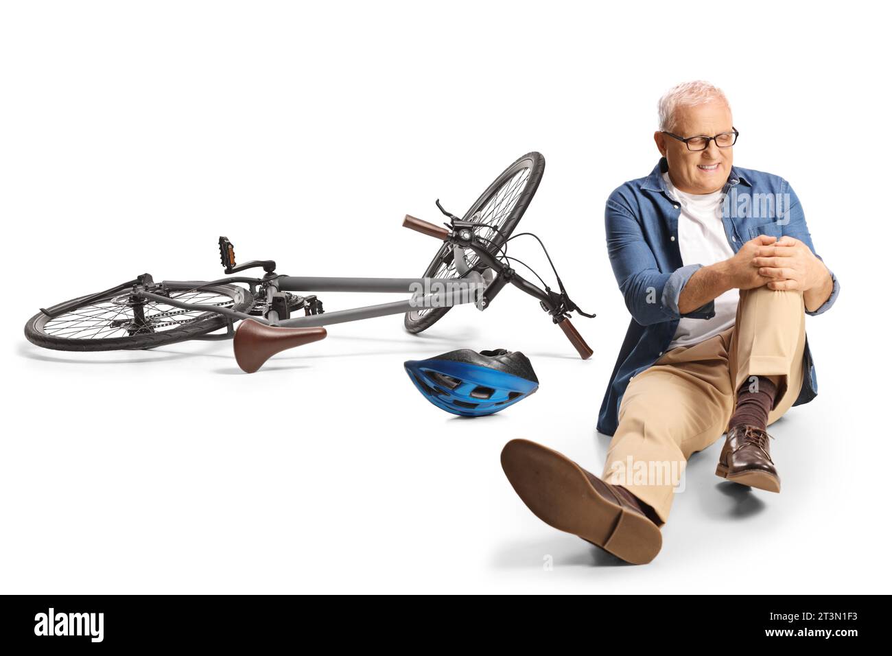 Man with an injured knee falling from a bicycle and sitting on the ...