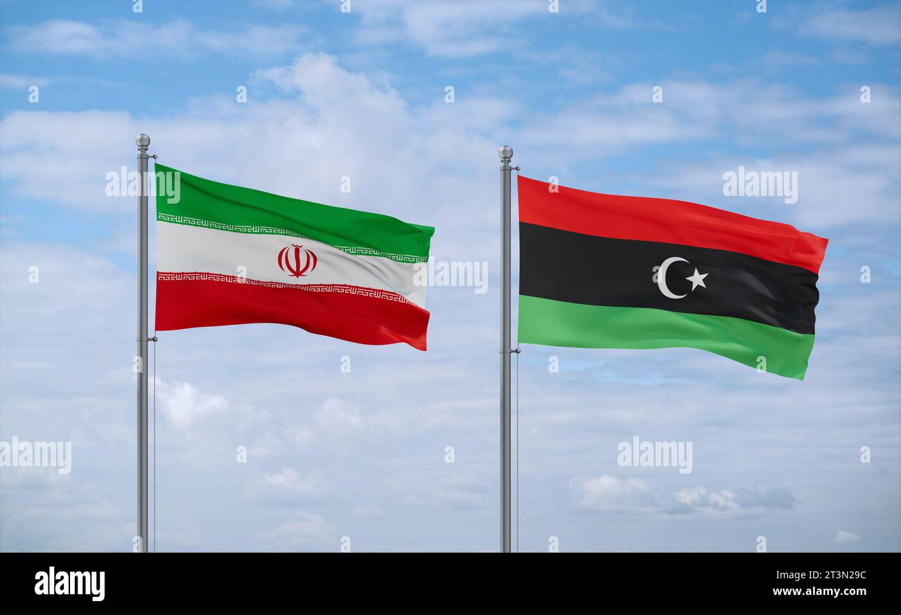 Libya and Iran flags waving together in the wind on blue cloudy sky ...