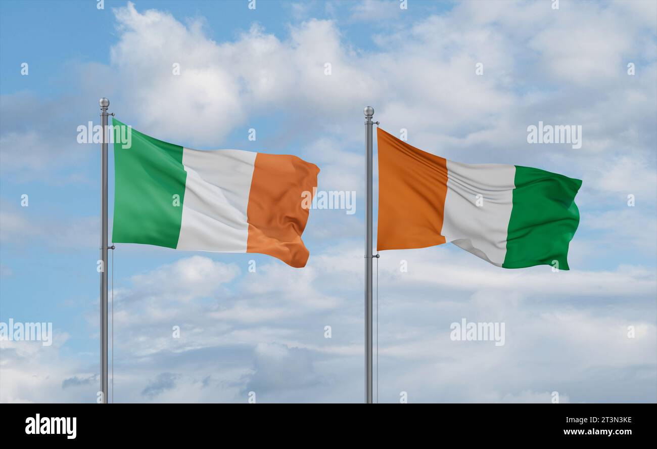 Ivory Coast or Cote d'Ivoire and Ireland flags waving together in the wind on blue cloudy sky ...