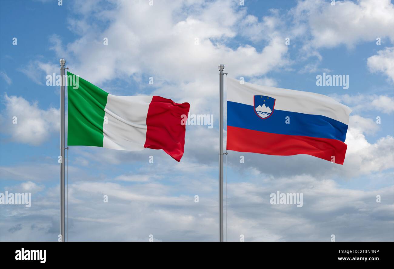 Slovenia and Italy flags waving together in the wind on blue cloudy sky ...