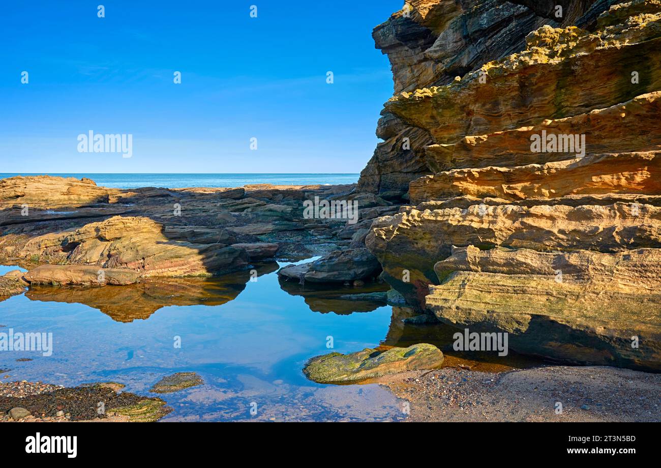 Hopeman Moray Coast Scotland a cliff of coloured sandstone and a rock ...