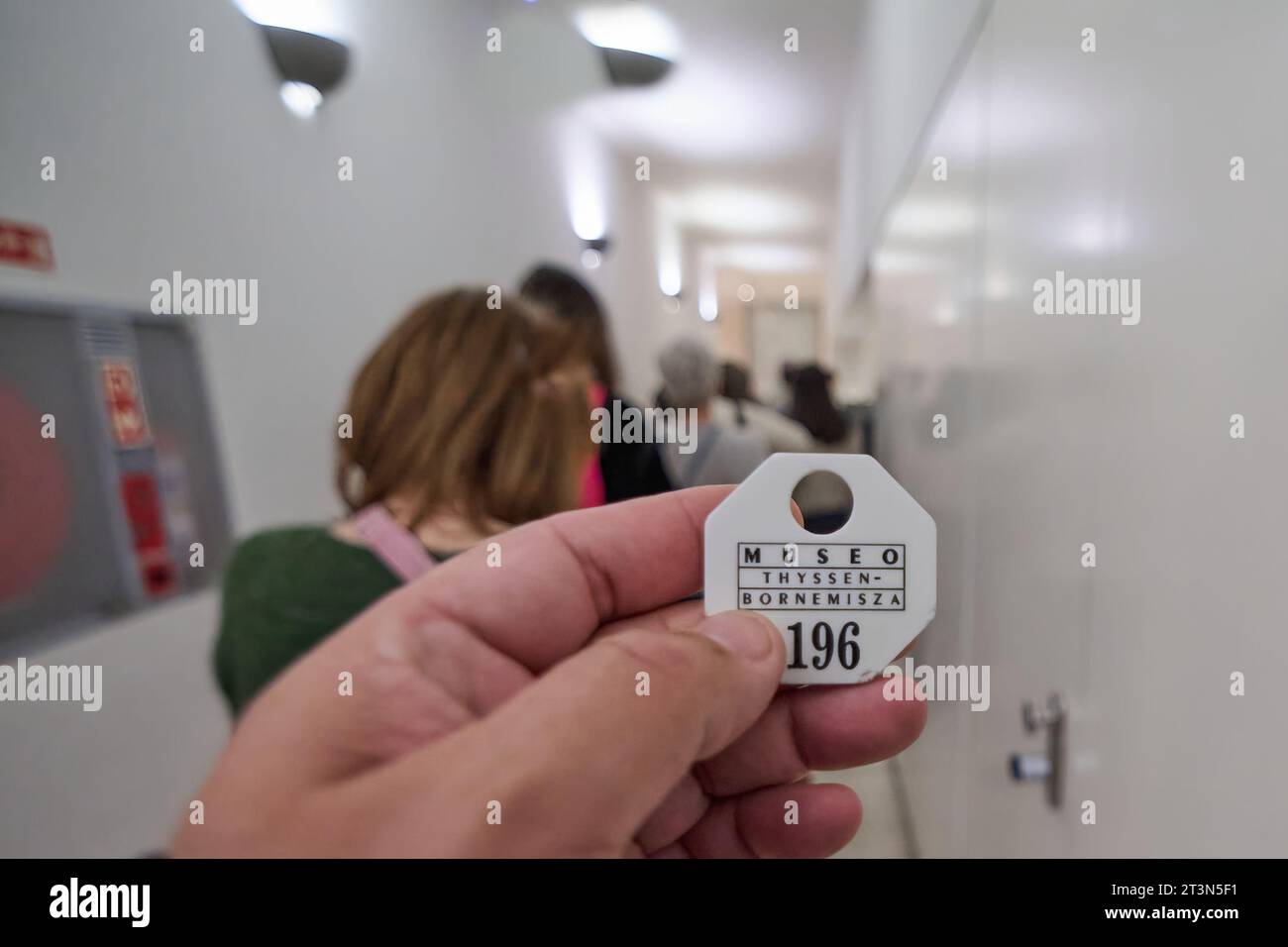 MADRID SPAIN - October 26, 2023: Hand holding cloakroom token of the ...