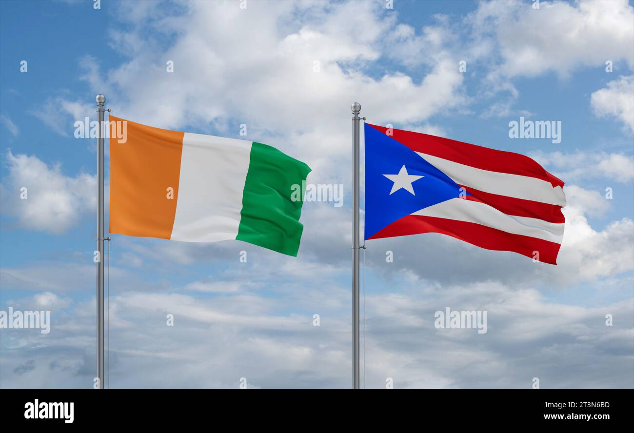 Puerto Rico and Ivory Coast flags waving together in the wind on blue ...