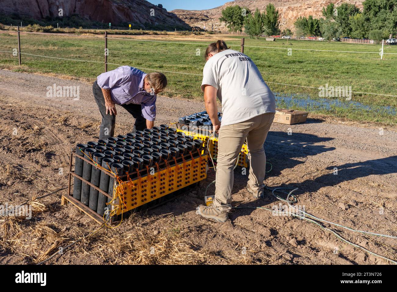 Technicians set up a battery of launchers for 4" pyrotechnic shells ...