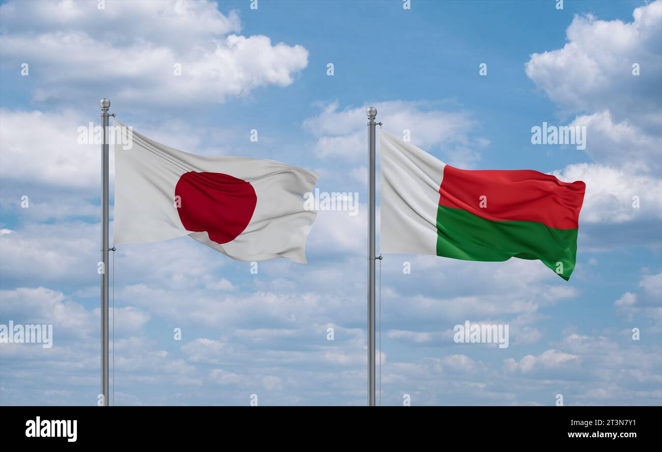 Madagascar and Japan flags waving together on blue cloudy sky, two country relationship concept ...