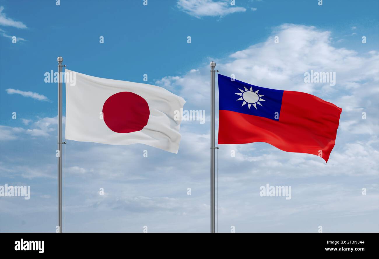 Taiwan and Japan flags waving together in the wind on blue cloudy sky ...