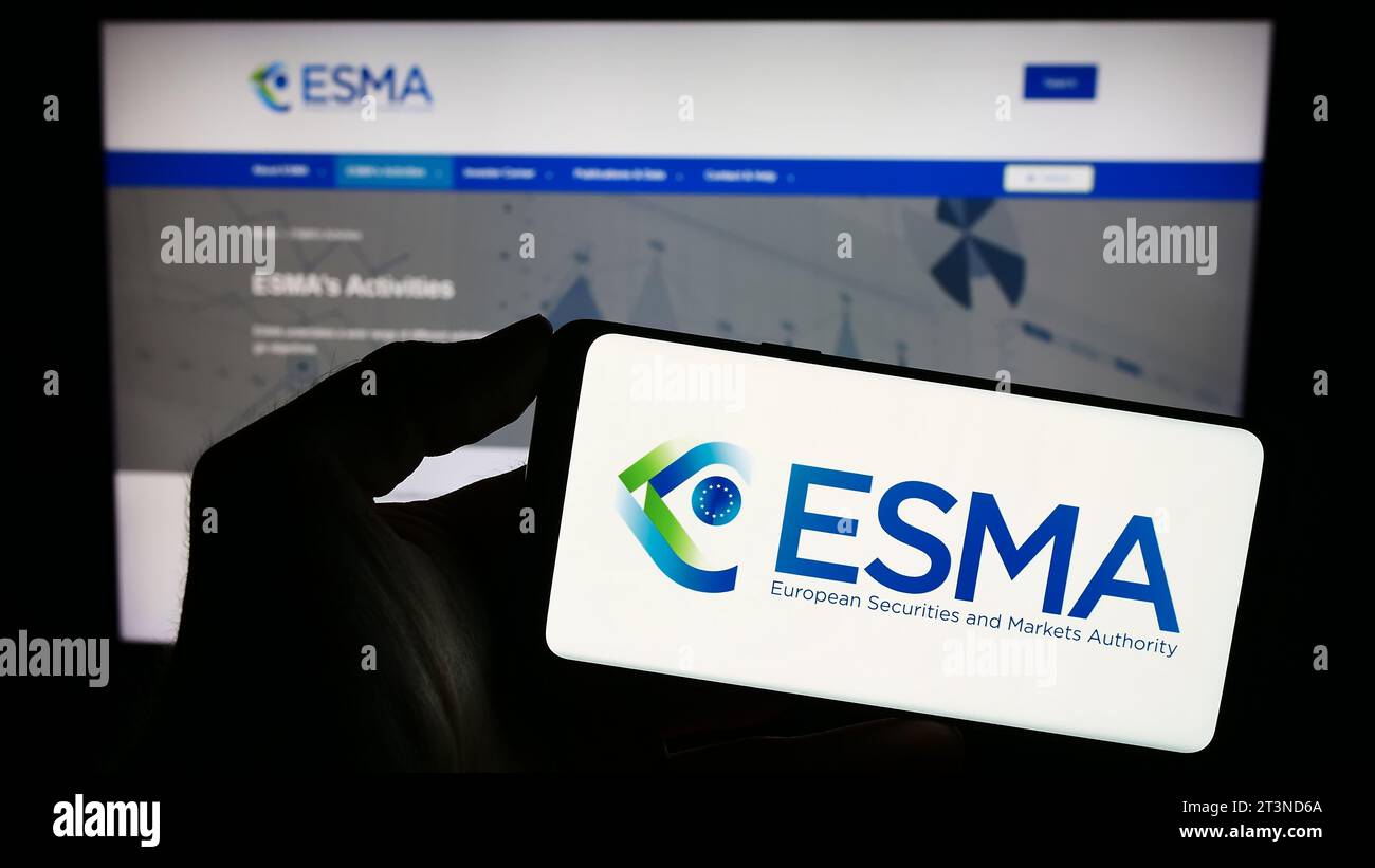 Person holding mobile phone with logo of European Securities and ...