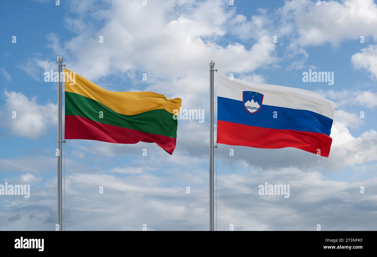 Slovenia and Lithuania flags waving together in the wind on blue cloudy ...