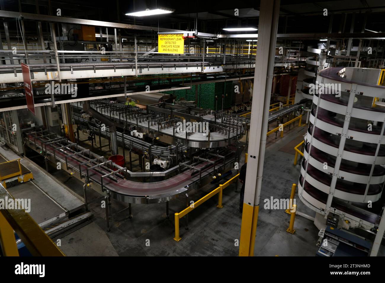 Coca-Cola cans move down a conveyer belt in the Swire Coca-Cola ...