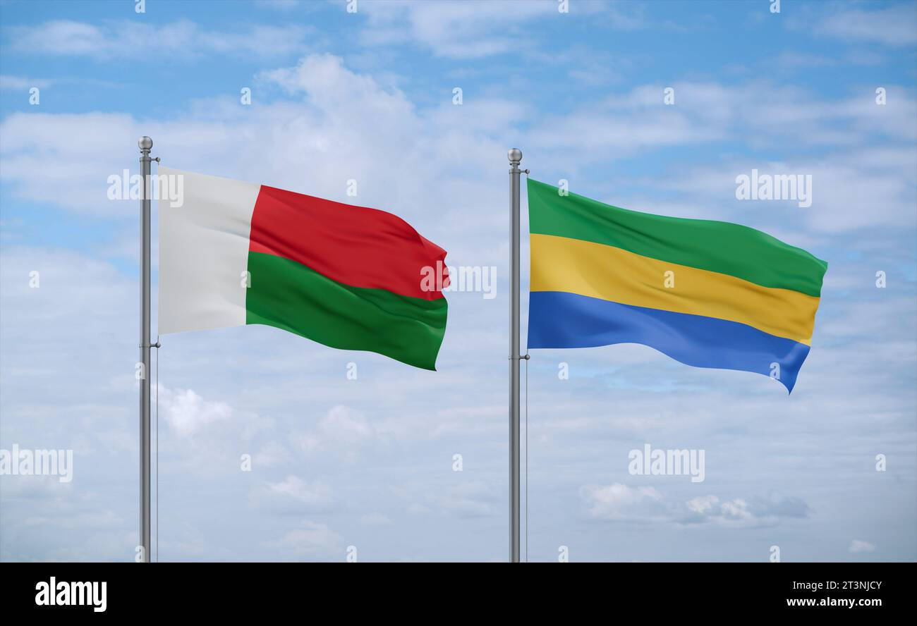 Gabon and Madagascar flags waving together on blue cloudy sky, two country relationship concept ...