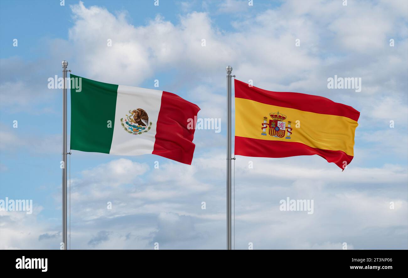 Spain and Mexico flags waving together in the wind on blue cloudy sky ...