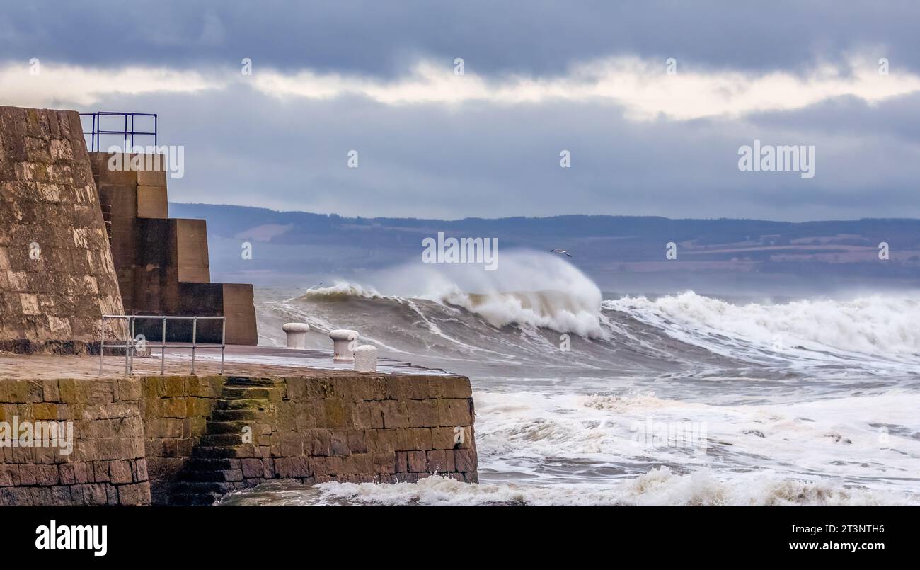 Large and stormy waves coming into a harbour Stock Photo - Alamy