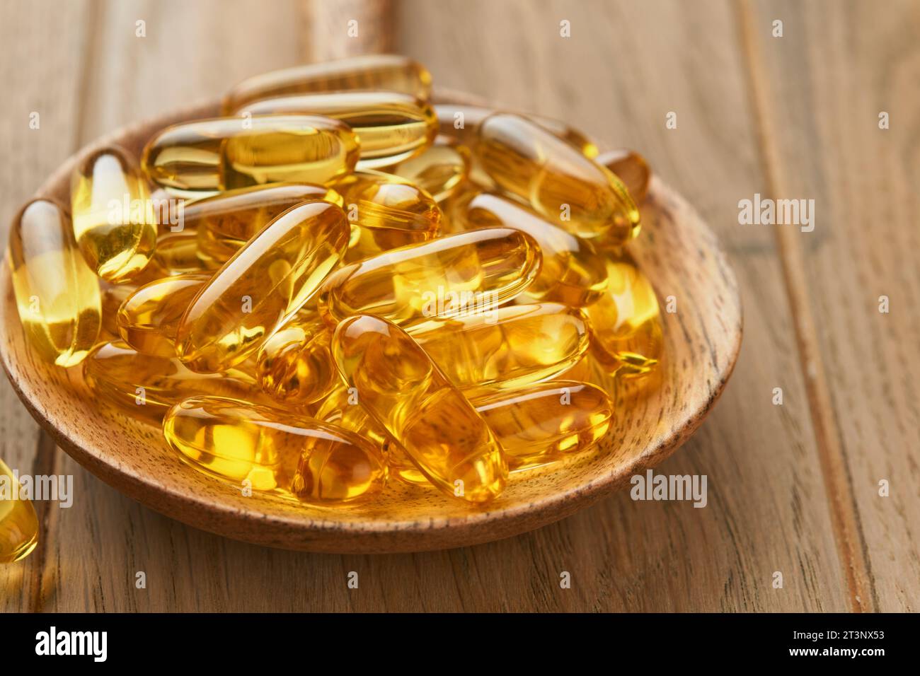 Close up capsules with Vitamin D, E or Omega 3,6,9 fatty acids in ...