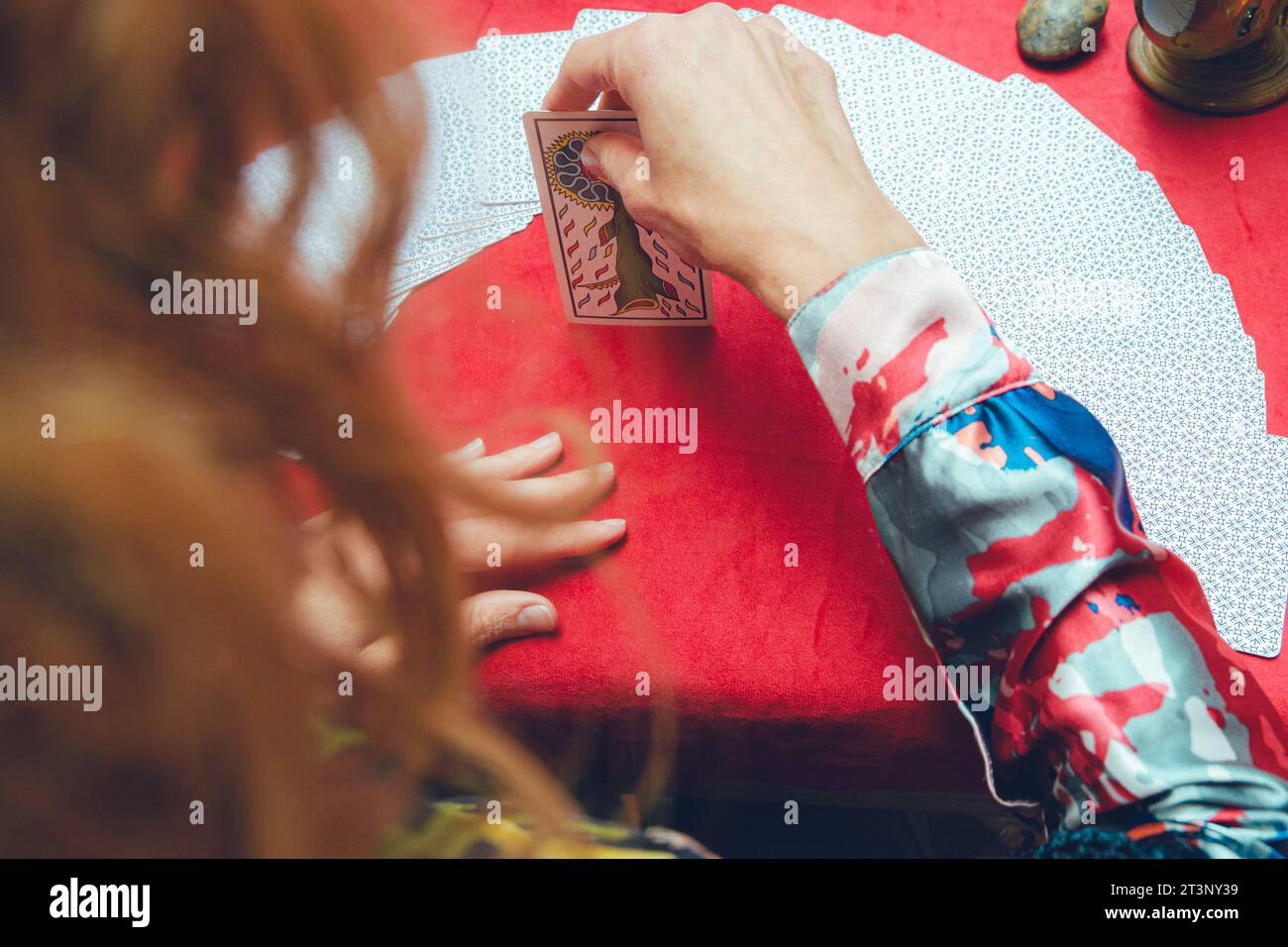 rear view of unrecognizable Caucasian woman, tarot reader, sitting ...