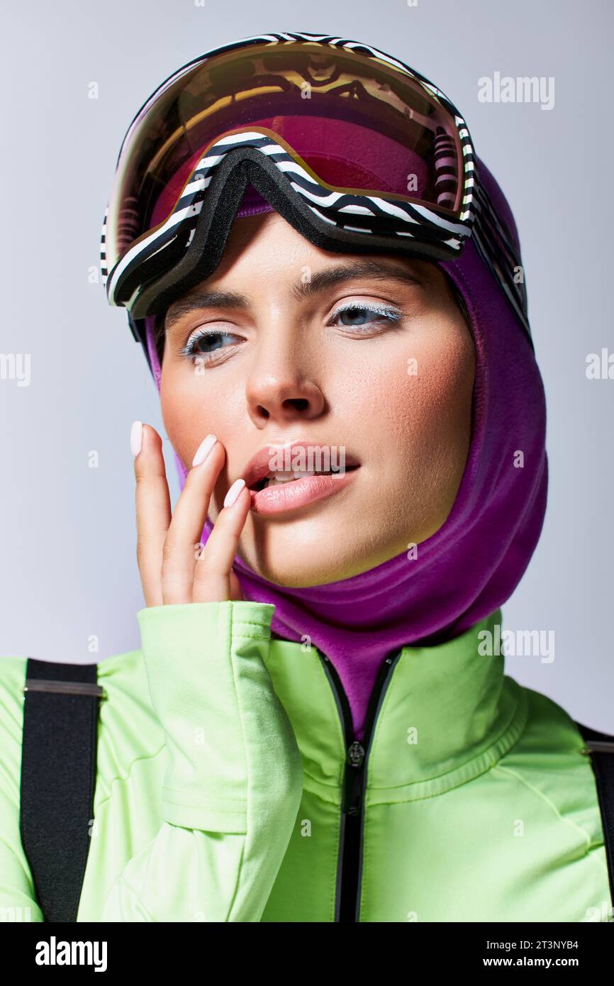 beautiful woman in winter ski clothes with balaclava on head posing ...