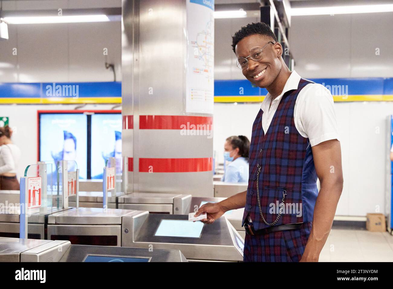 man passing the ticket for access to a subway stations Stock Photo - Alamy