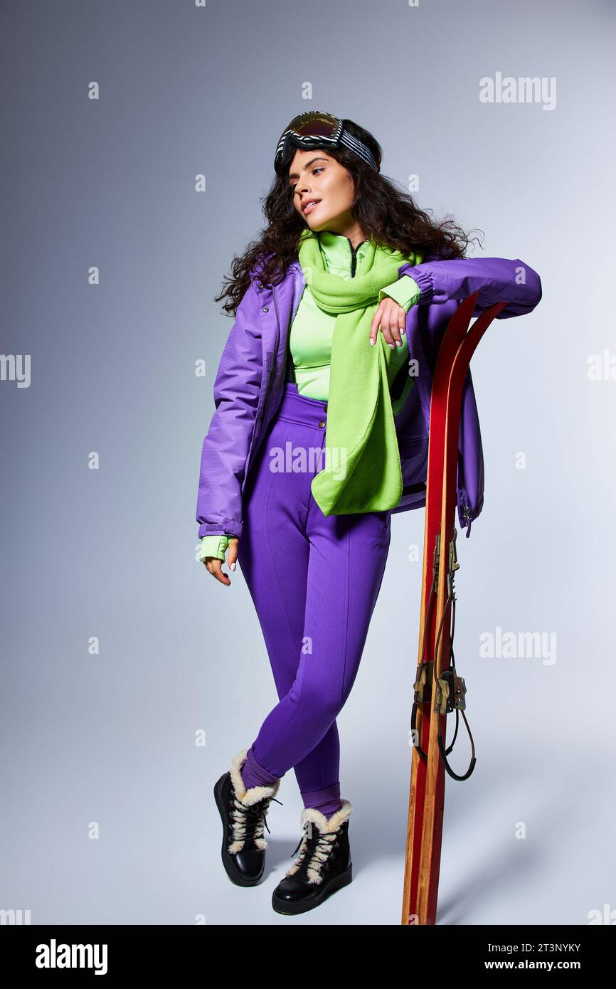winter activity, charming woman with curly hair posing in active wear ...