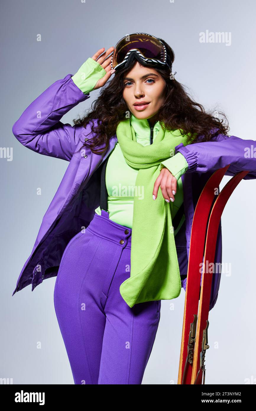 winter activity, attractive woman with curly hair posing in active wear ...