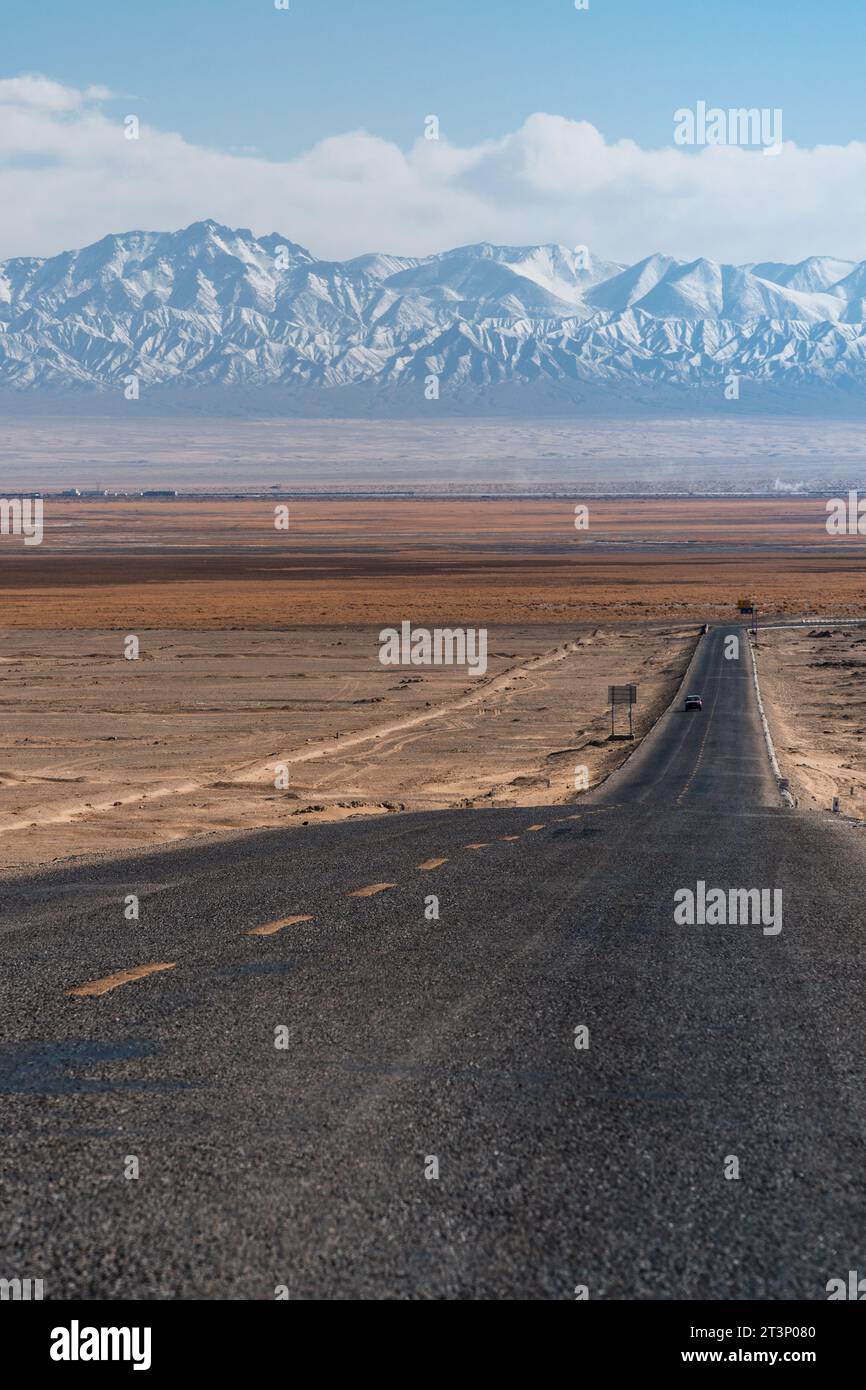 Tar Road Under Snowy Mountains in Western China Stock Photo - Alamy