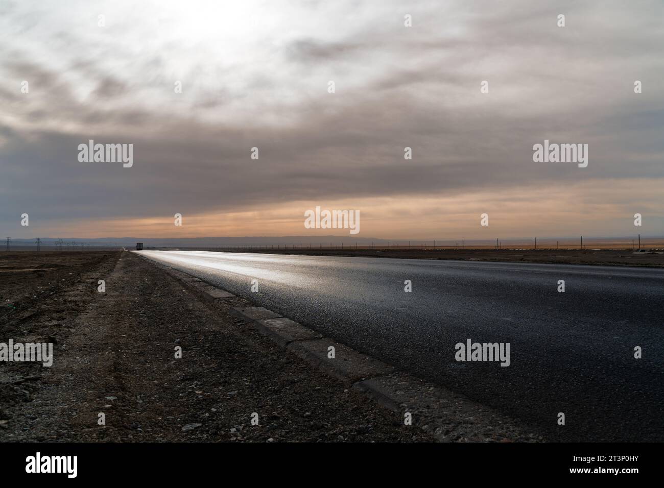 Tar Road Under Dark Clouds Stock Photo - Alamy