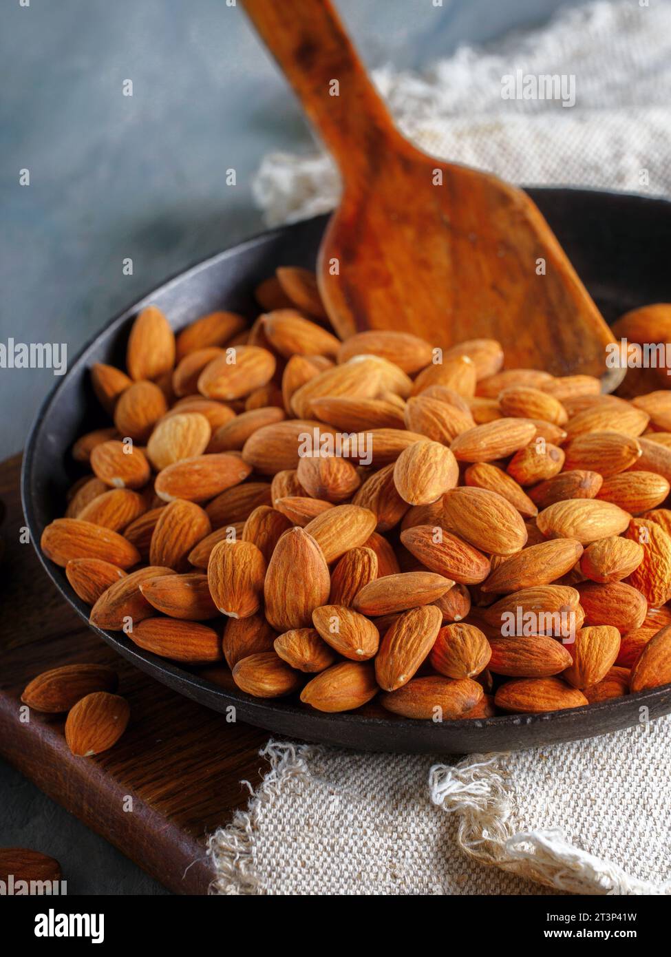 Peeled almonds lie in plate. Healthy nut. Advertising vertical ...