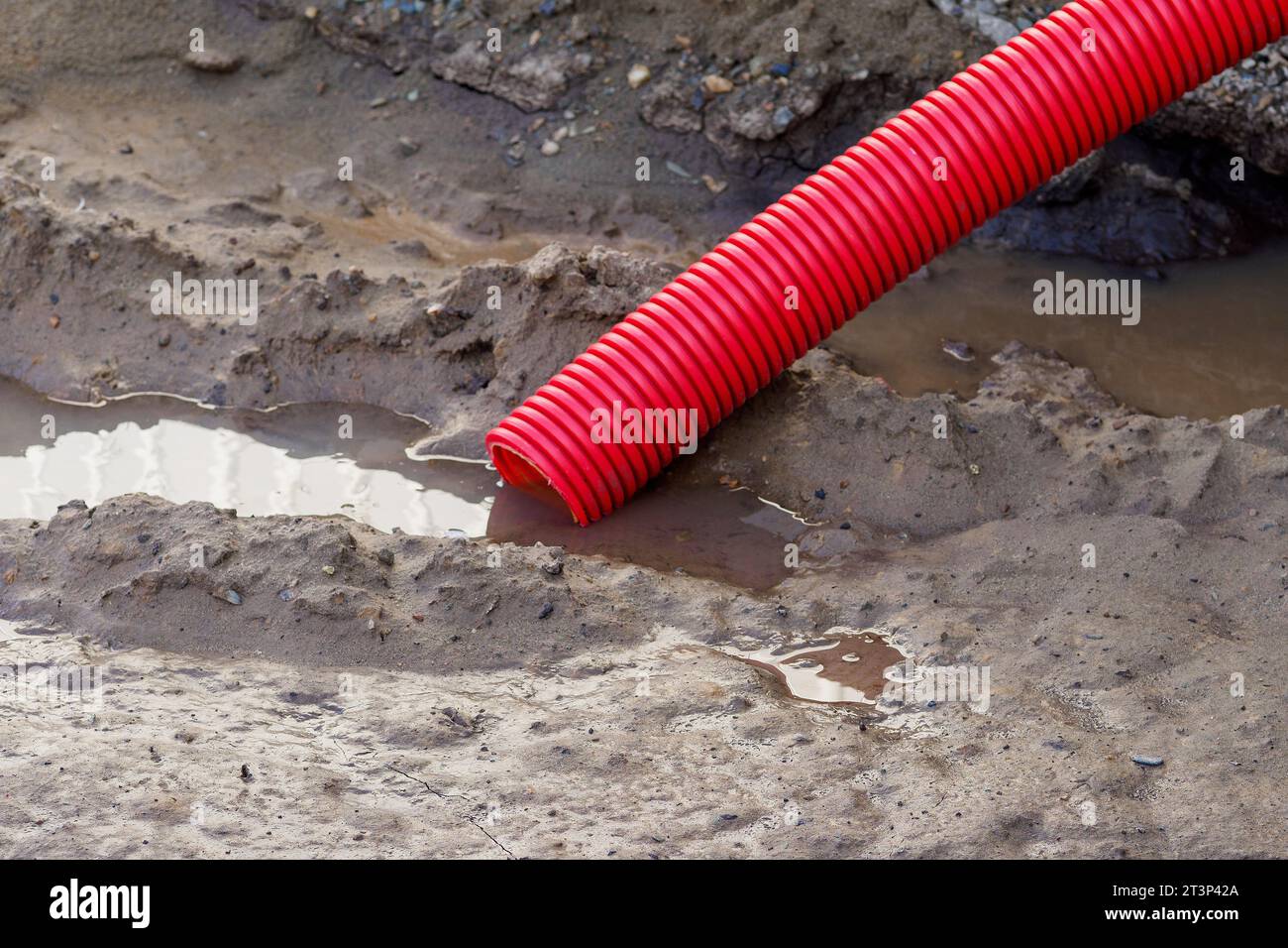 Pumping water after flooding, flooding or hurricane. Red corrugated ...