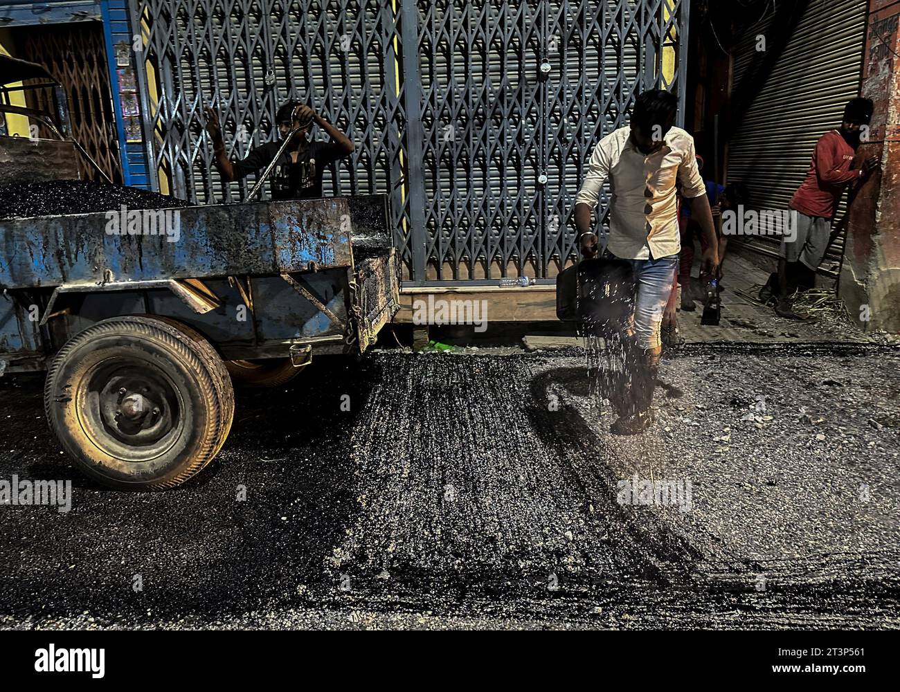 Kathmandu, Bagmati, Nepal. 26th Oct, 2023. Indian migrant workers lay hot asphalt while ...