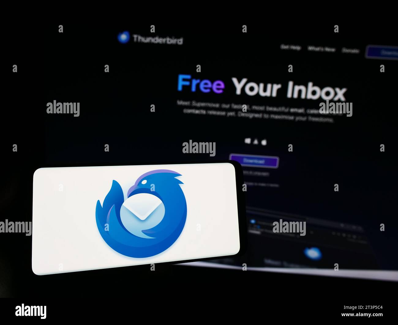 Person holding mobile phone with logo of open-source e-mail client ...