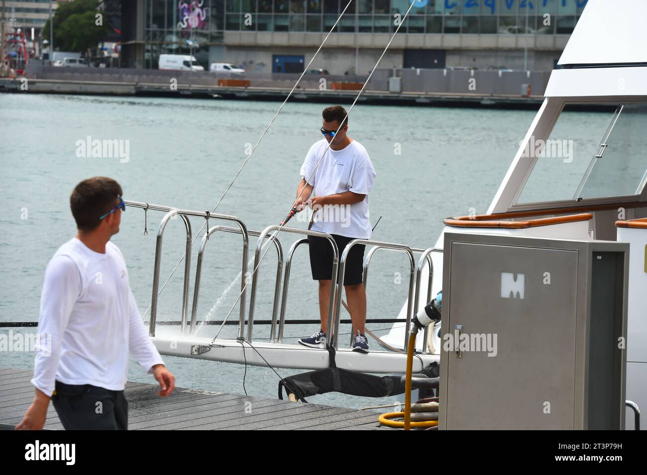 Deck crew working on super yacht in preparation for guests - Barcelona ...