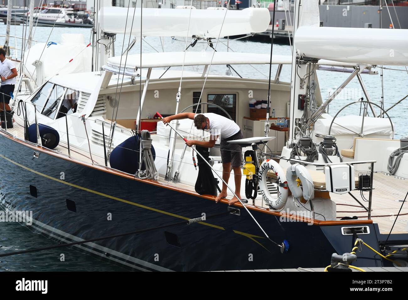 Deck crew working on super yacht in preparation for guests - Barcelona ...