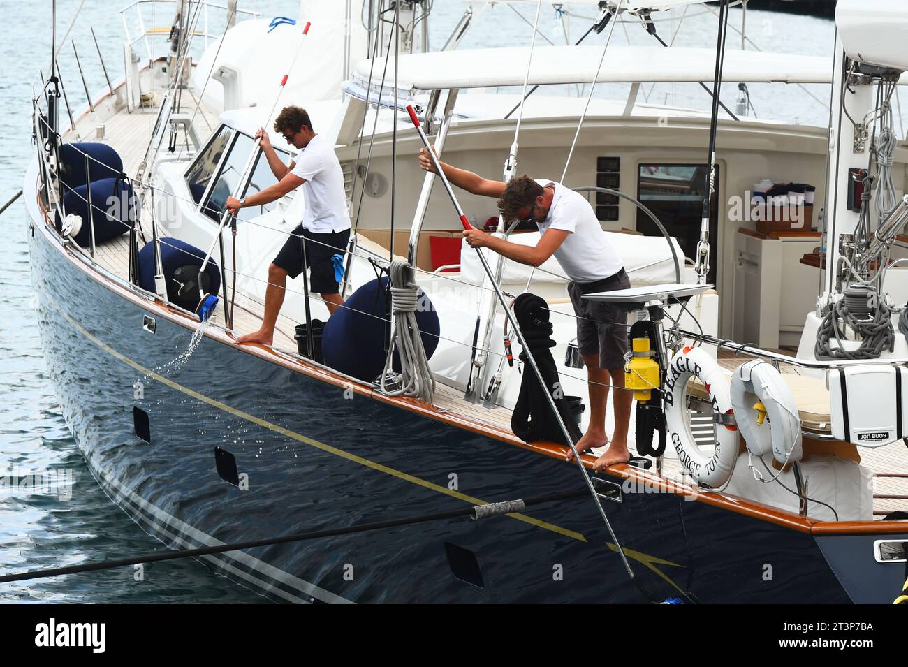 Deck crew working on super yacht in preparation for guests - Barcelona ...