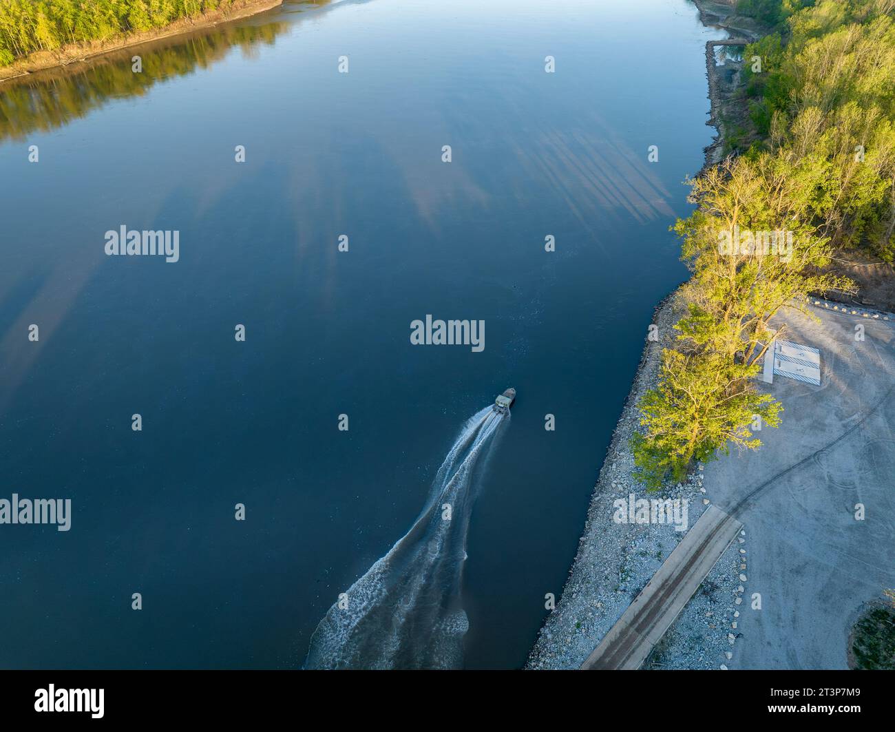 fishing boat leaving a ramp - sunrise aerial view of Missouri River at ...
