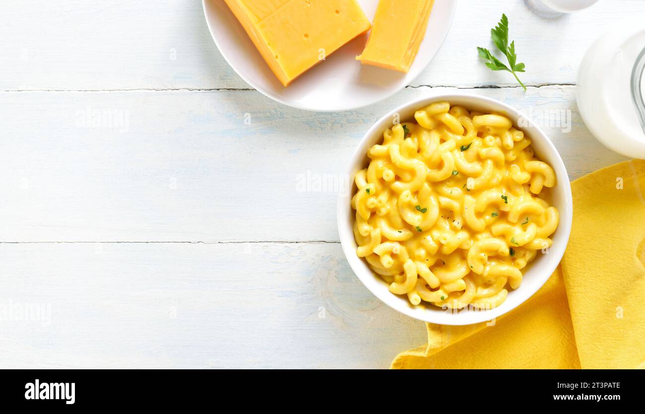 Macaroni and cheese in bowl over light wooden background with free ...