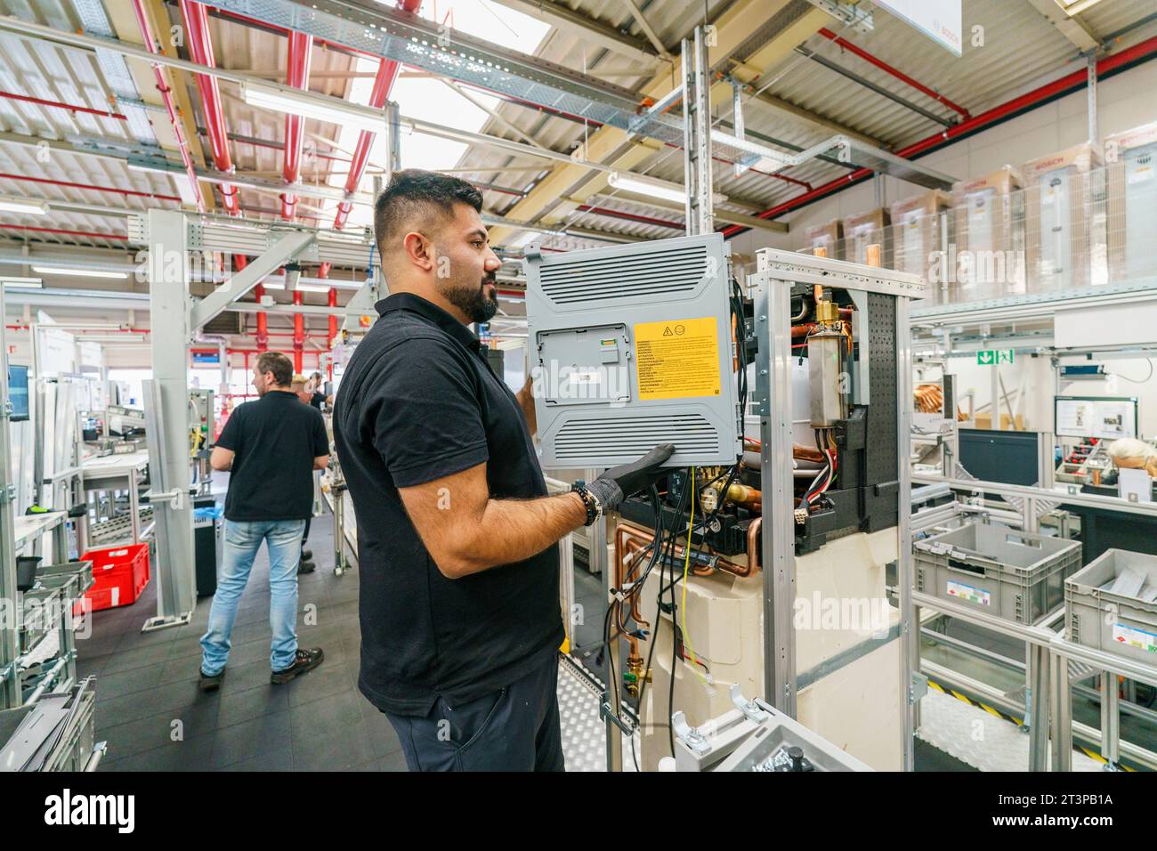 Eschenburg, Germany. 25th Oct, 2023. Associates work on a heat pump in ...