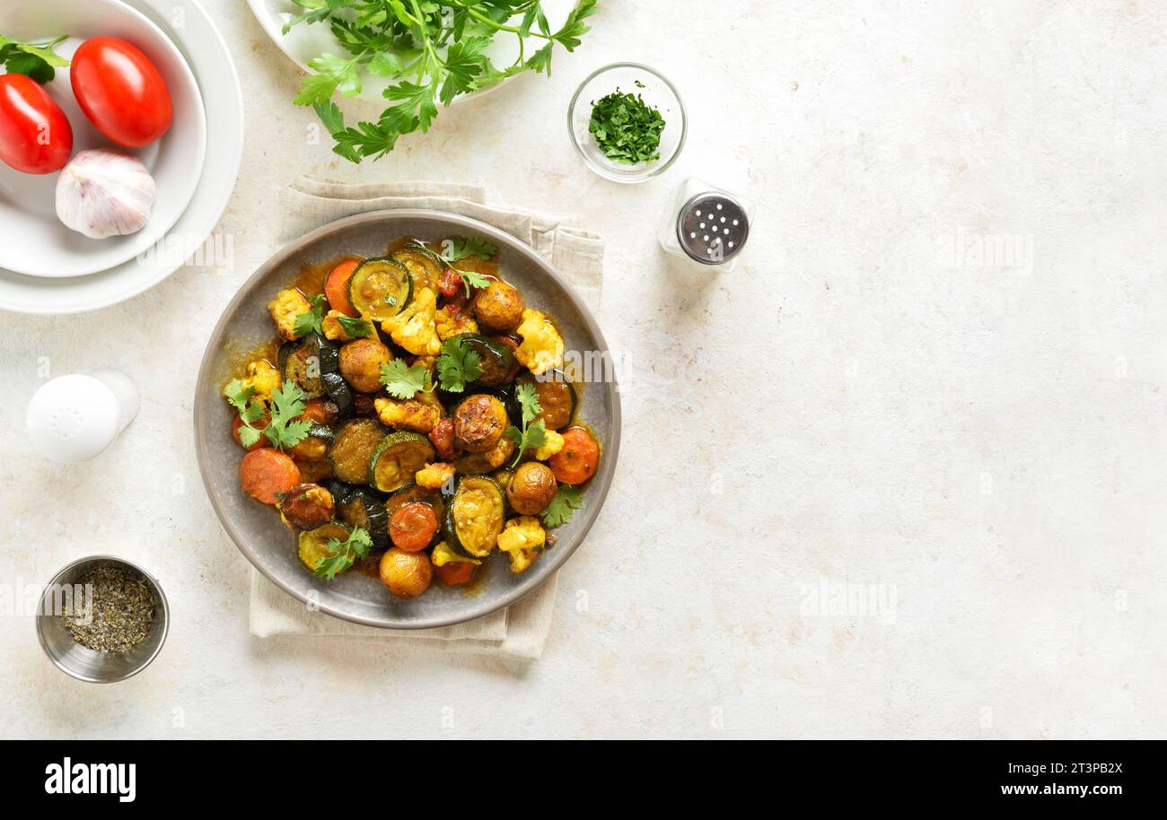 Vegetarian stew with mixed vegetables on plate over light background ...