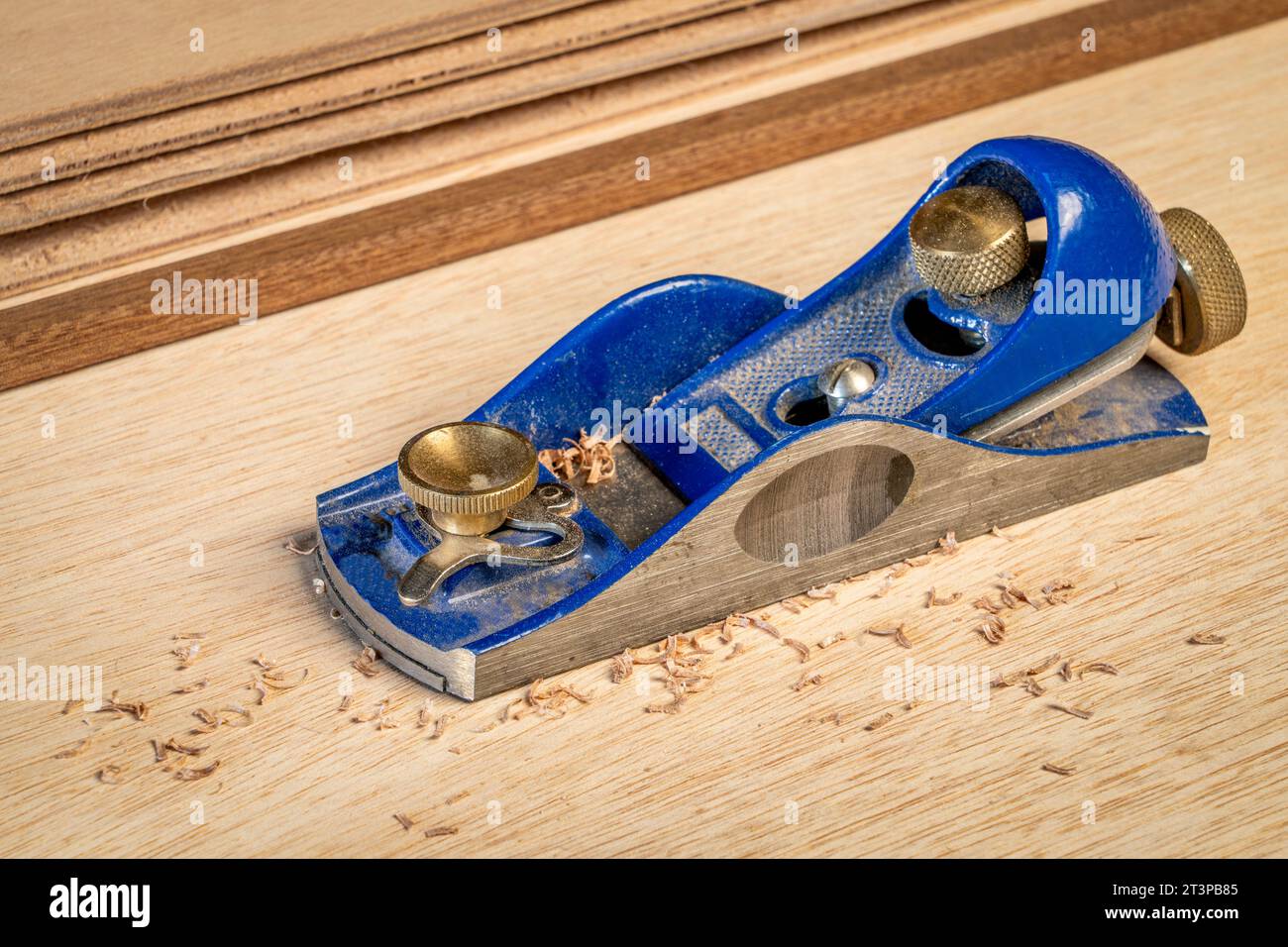dusty hand block planer against okoume plywood background with some ...