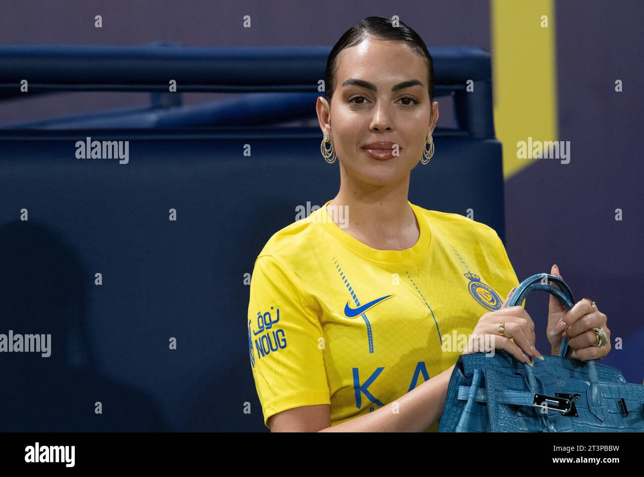 Georgina Rodriguez poses on the pitch wearing Guess jeans and Le Silla ...