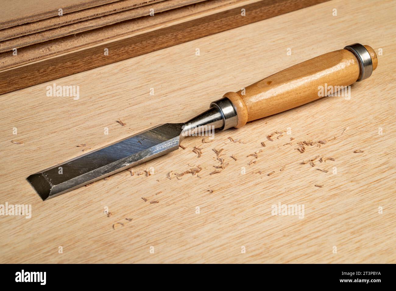 wood chisel against okoume plywood - woodworking concept Stock Photo ...