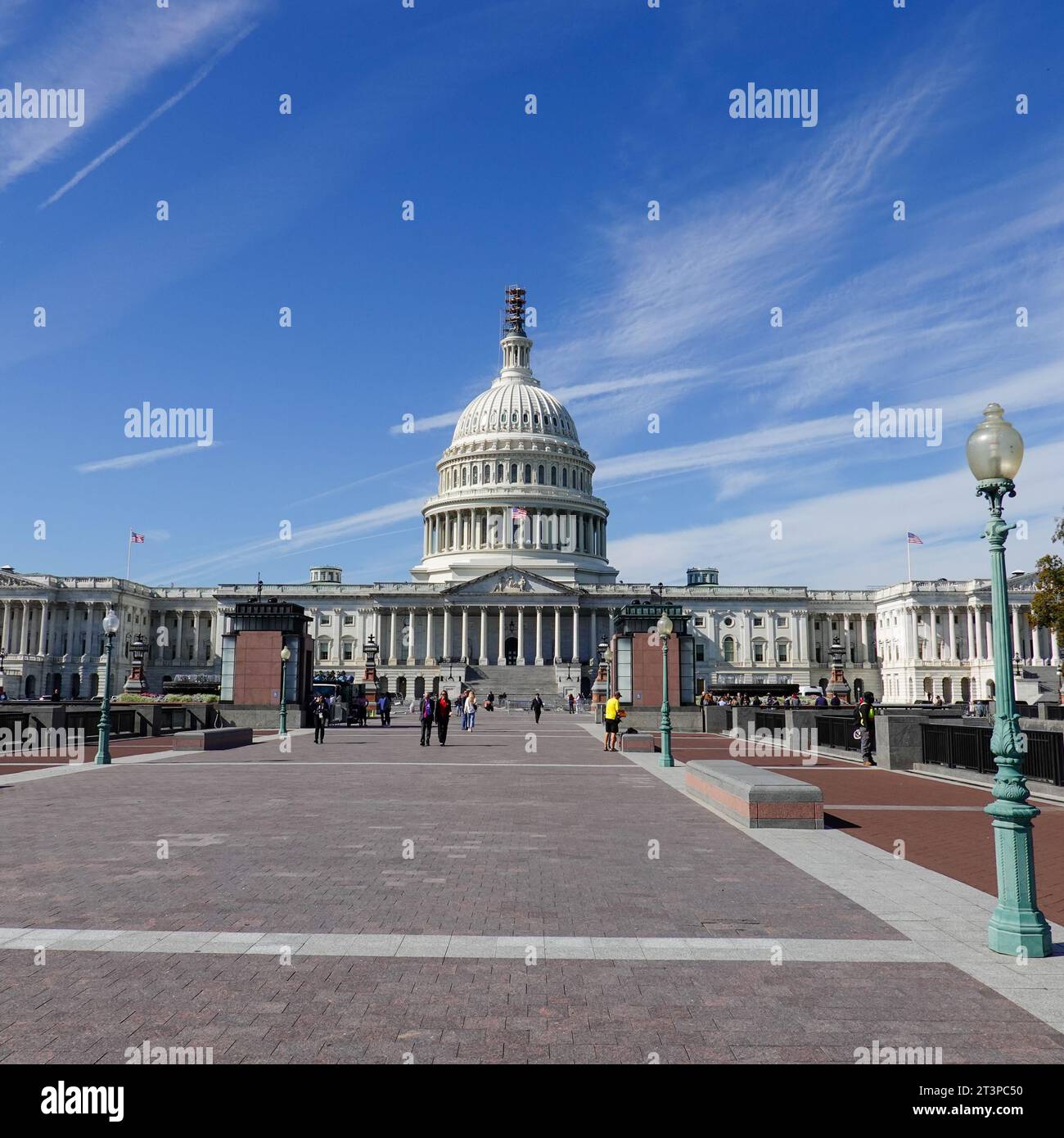 US Capitol Building, viewed from the east, with people and blue skies ...
