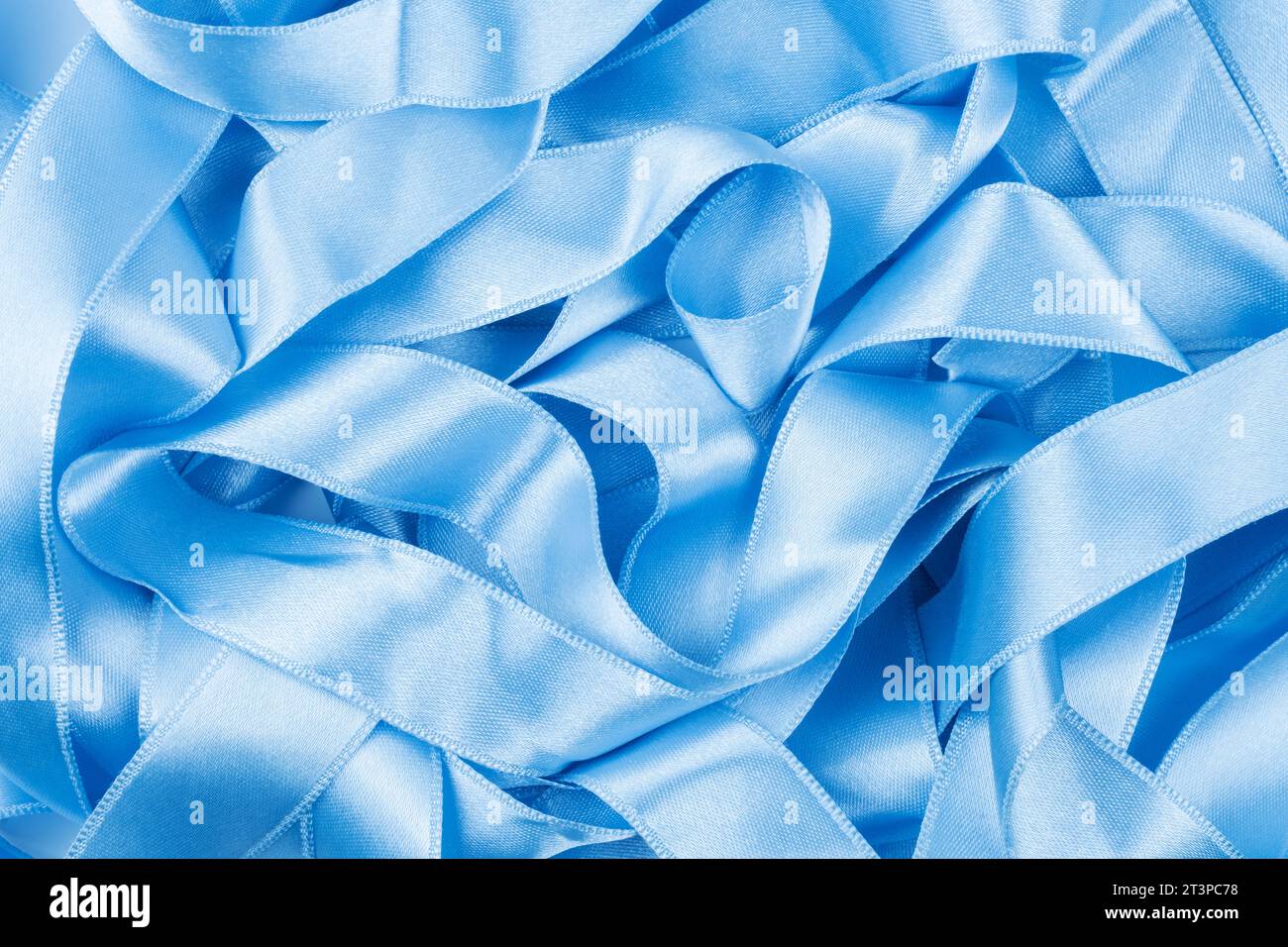 Abstract light blue curly satin ribbon background Stock Photo - Alamy