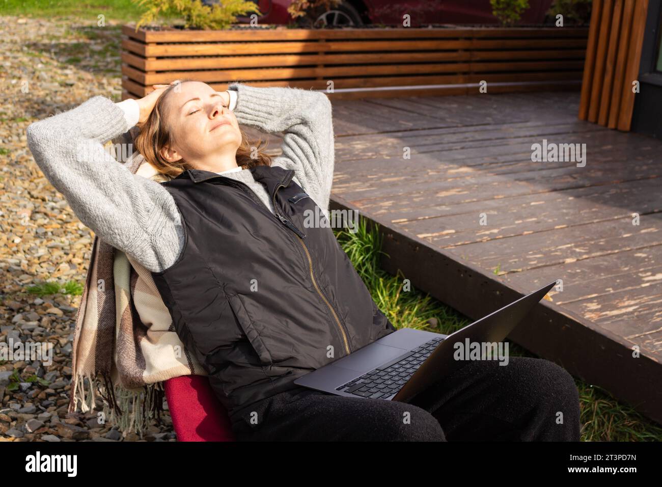 Satisfied woman with laptop in garden. Happy freelancer with notebook ... Satisfied woman with laptop in garden. Happy freelancer with notebook ...