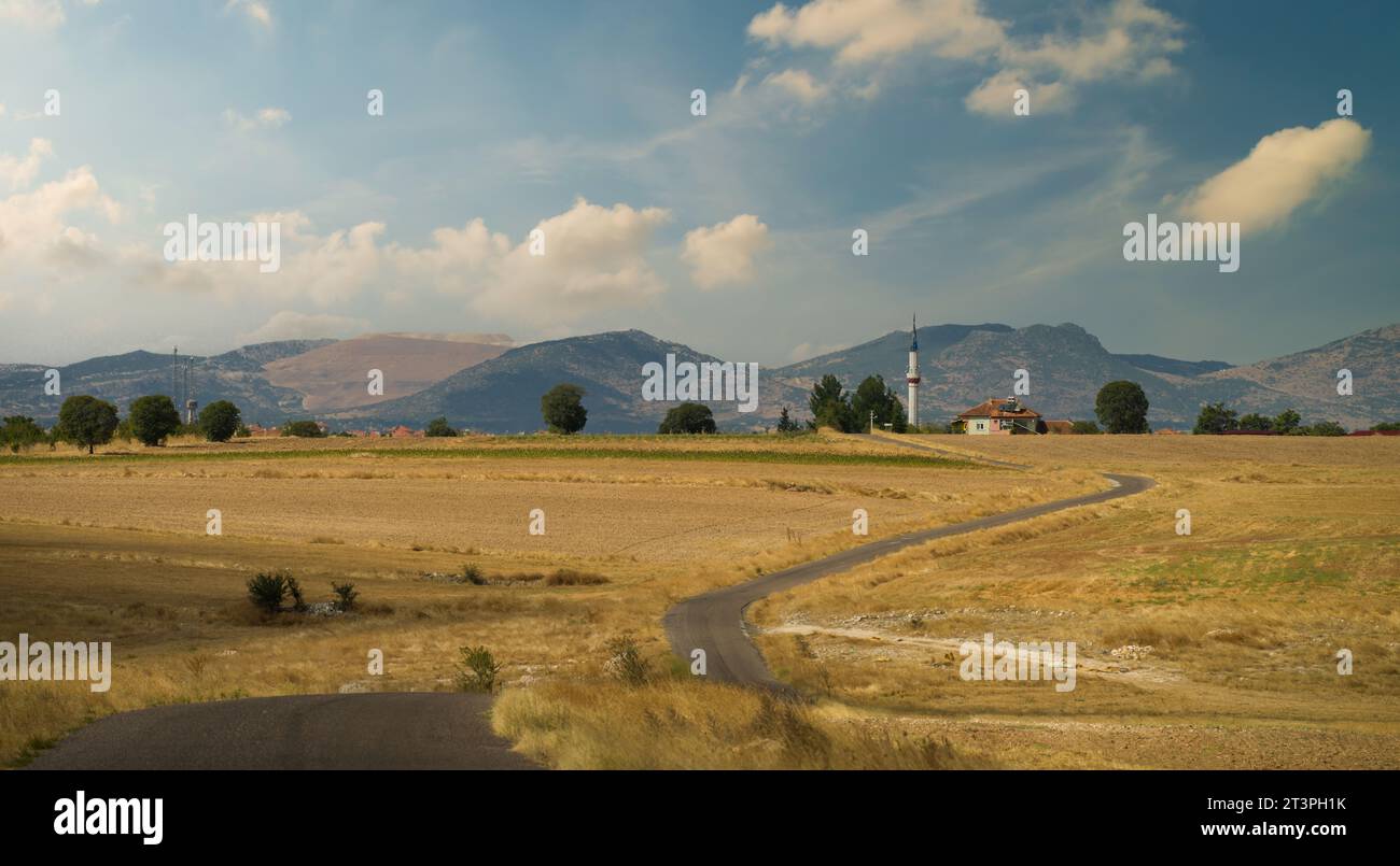 Turkish village. Asphalt road from the crop fields to the village ...