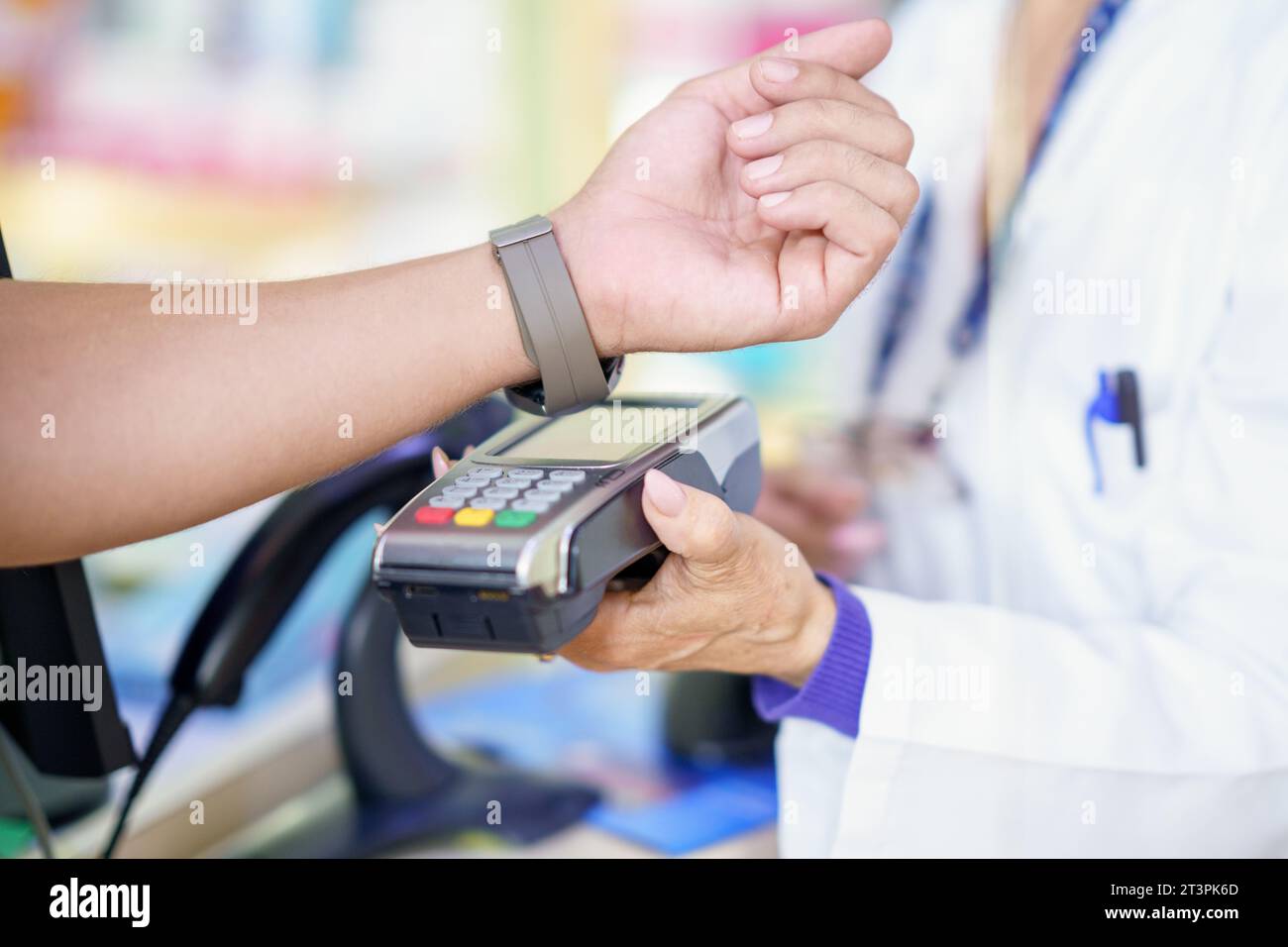 Man paying by smartwatch with dataphone in a pharmacy Stock Photo - Alamy
