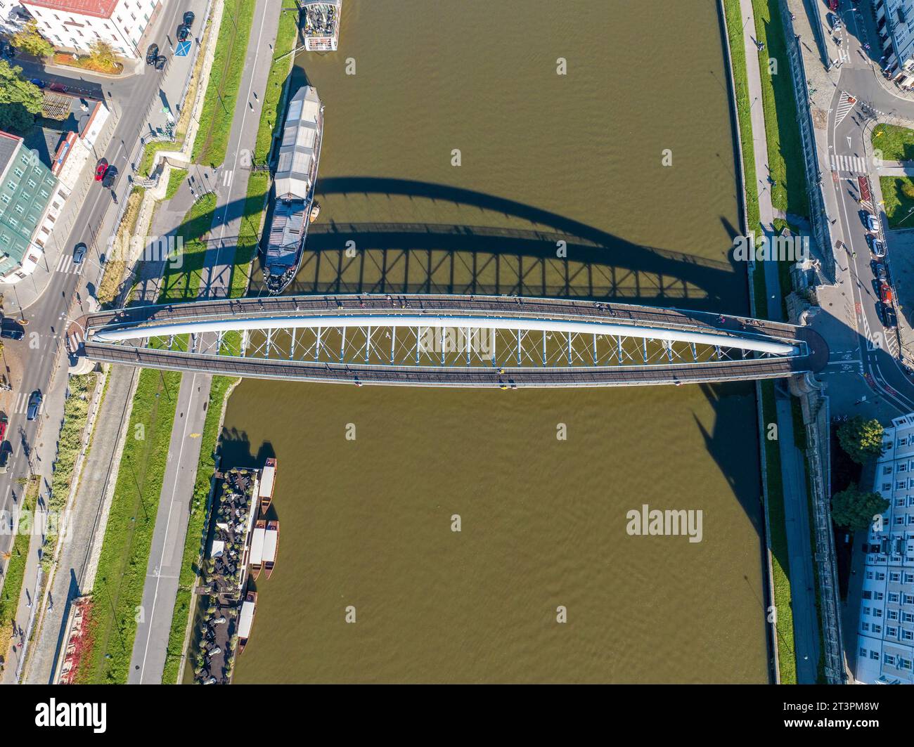 Krakow, Poland. Double suspension bridge under one arc: footbridge and ...
