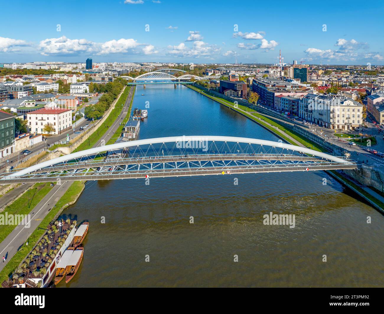 Krakow, Poland. Double suspension bridge under one arc: footbridge and ...